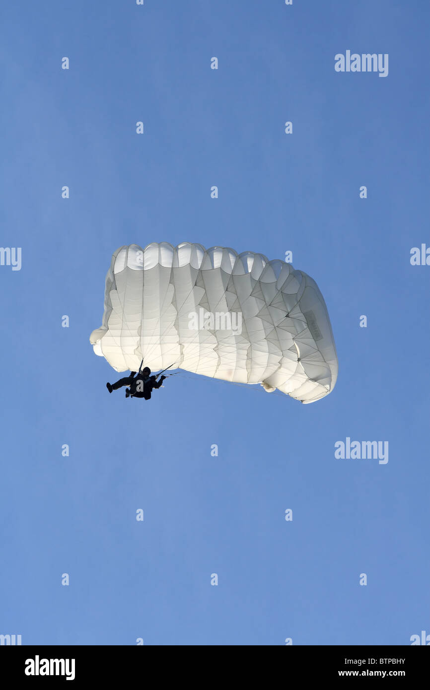 Parachute on a bright blue sky. Training of paragliders. Sport airfield ...