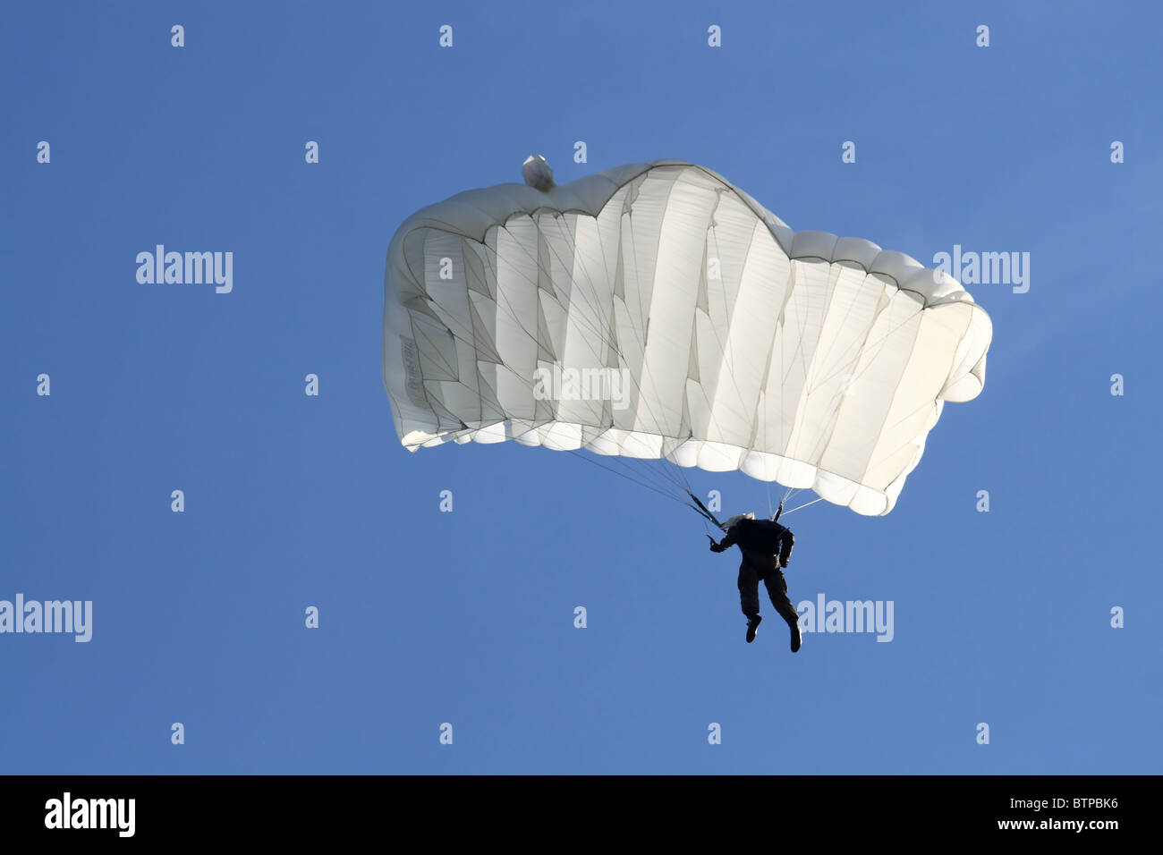 Parachute on a bright blue sky. Training of paragliders. Sport airfield ...