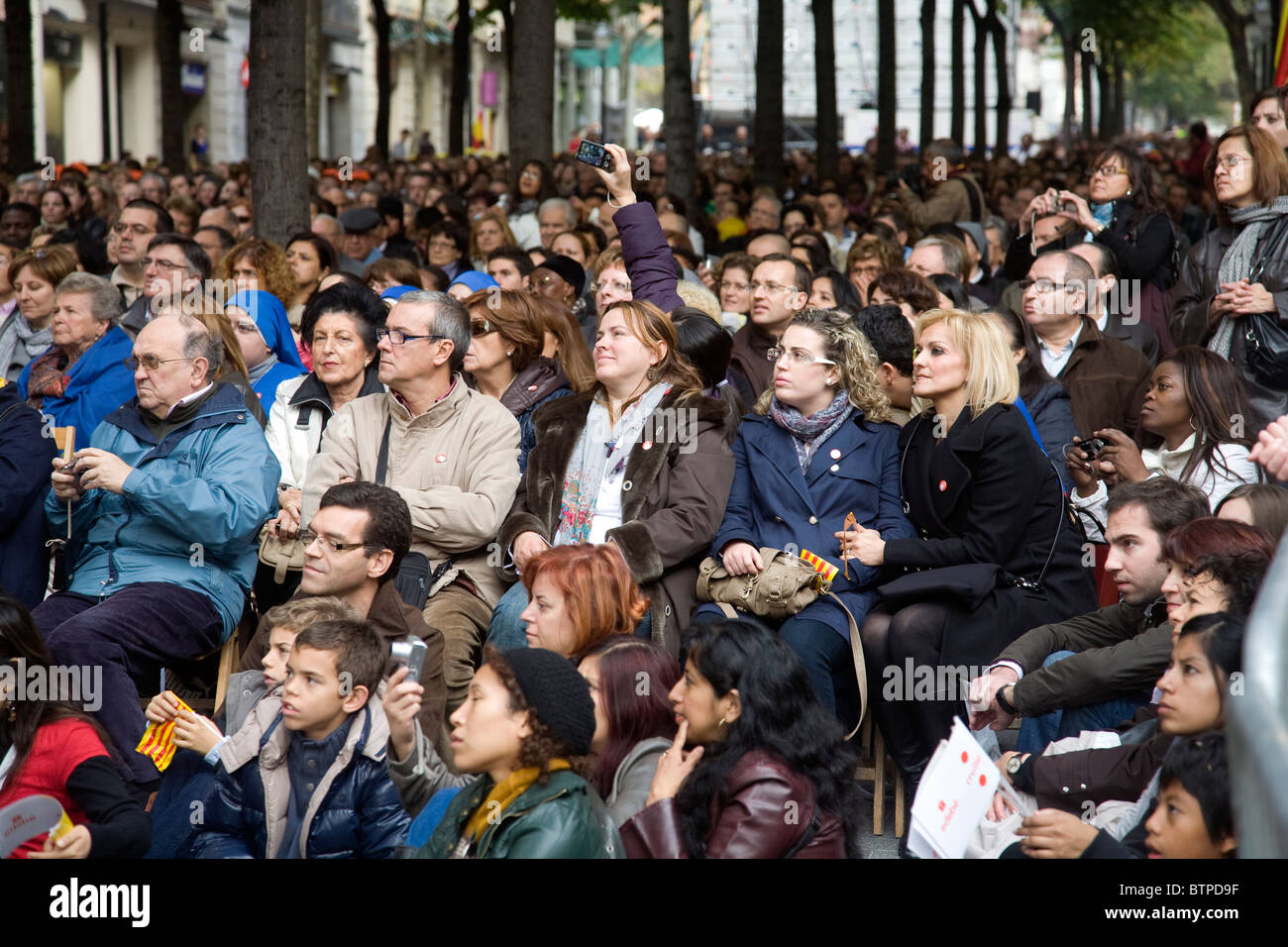 Seated crowd watching the consecration of the Sagrada Familia on a ...