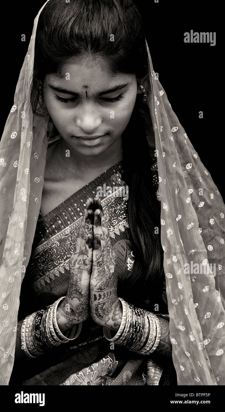 Indian girl wearing traditional silk sari with henna prayer hands ...