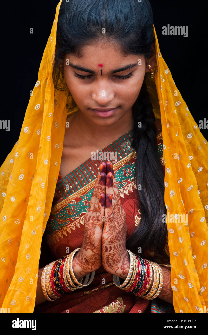 Indian girl wearing traditional silk sari with henna prayer hands ...