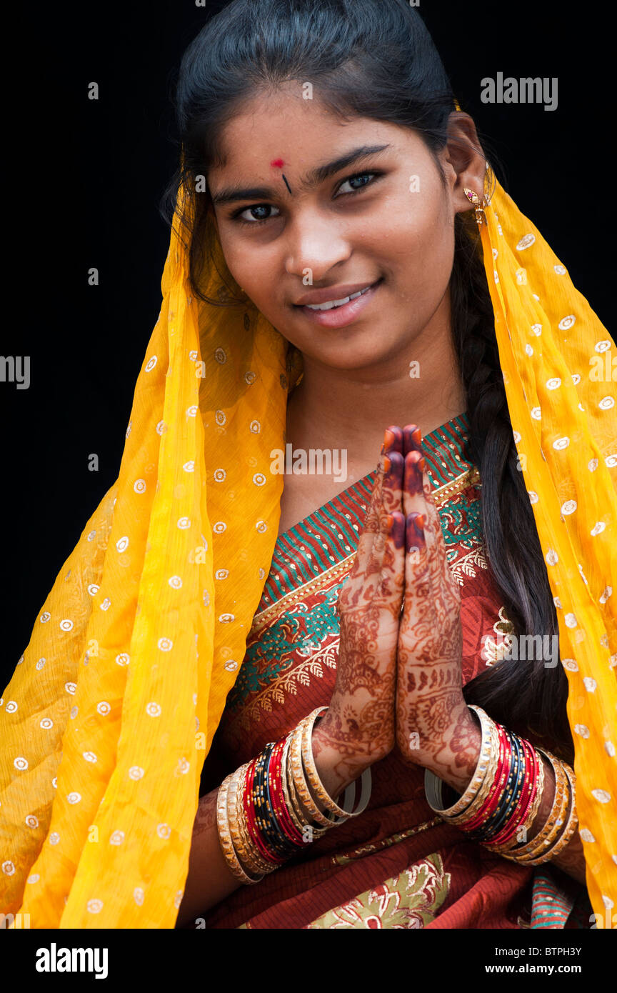 Indian girl wearing traditional silk sari with henna prayer hands ...