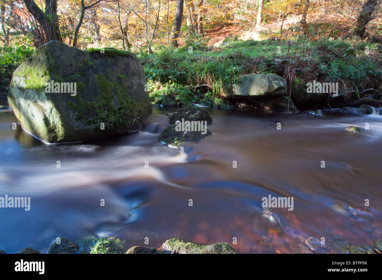 Burbage Brook running over rocks and through Padley Gorge in the Peak ...
