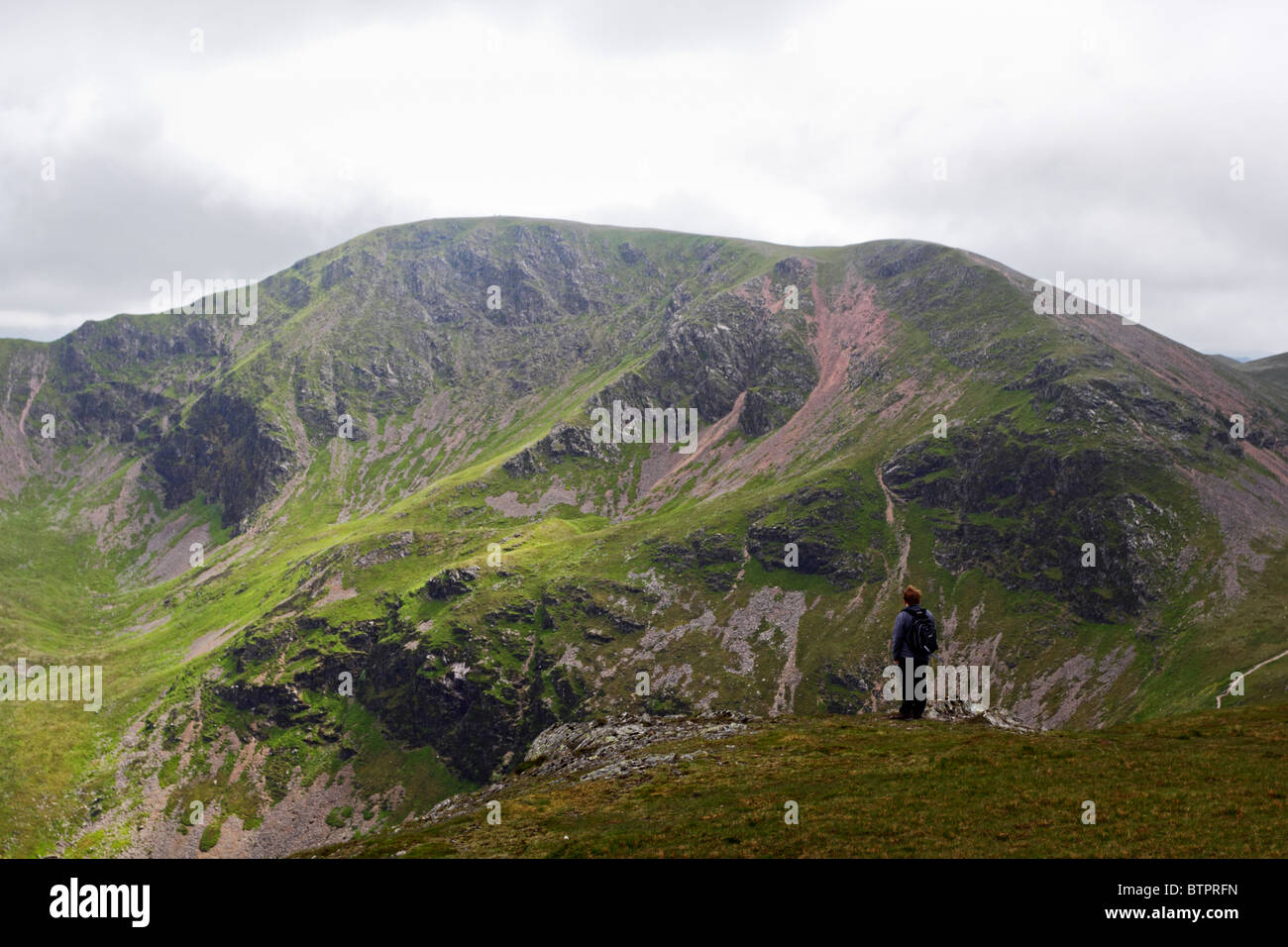 Walker in front of Eel Crag in the Lake District National Park, Cumbria ...