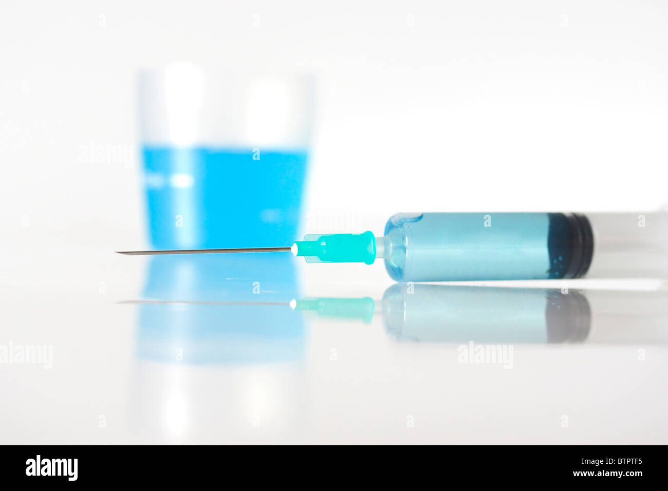 Syringe with blue liquid Stock Photo - Alamy