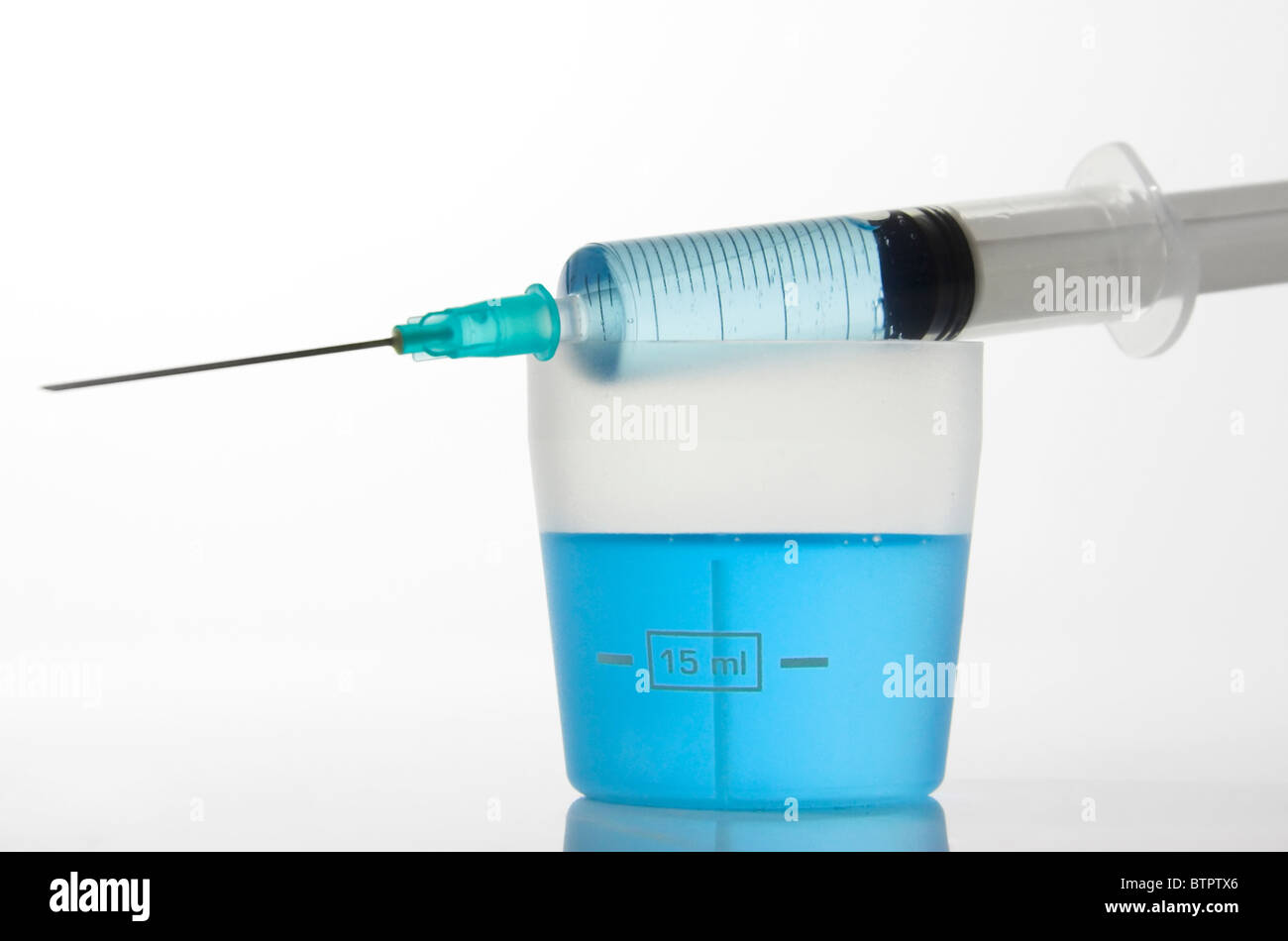 Syringe with blue liquid Stock Photo - Alamy