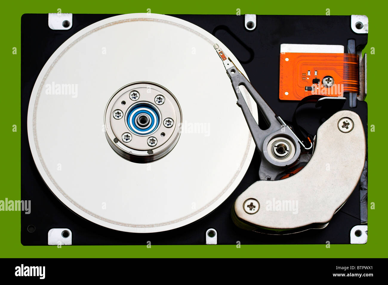 Open hard disk drive, in a green background Stock Photo - Alamy