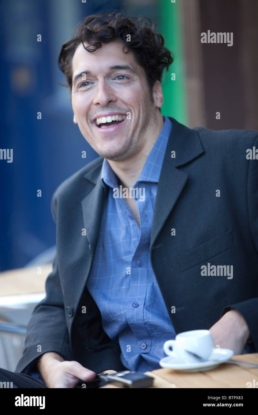 good looking man smiling off camera left Stock Photo - Alamy