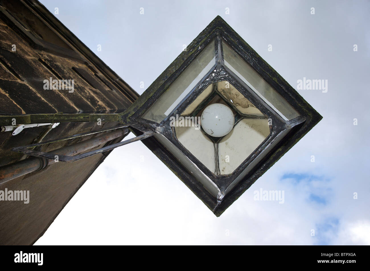 Lamp from below attached to corner of building Stock Photo - Alamy