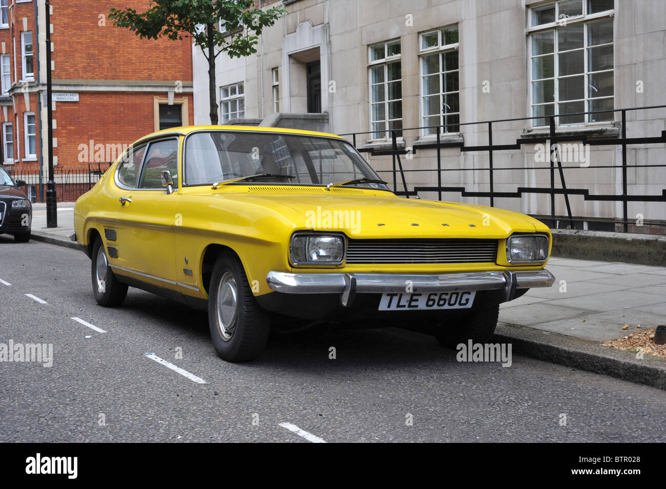 Yellow ford capri parked on street Stock Photo - Alamy
