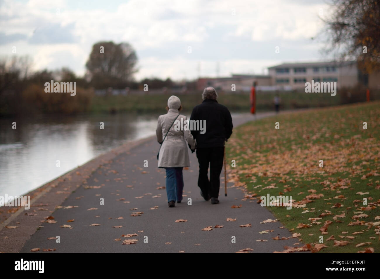 couple stroll by river Stock Photo - Alamy