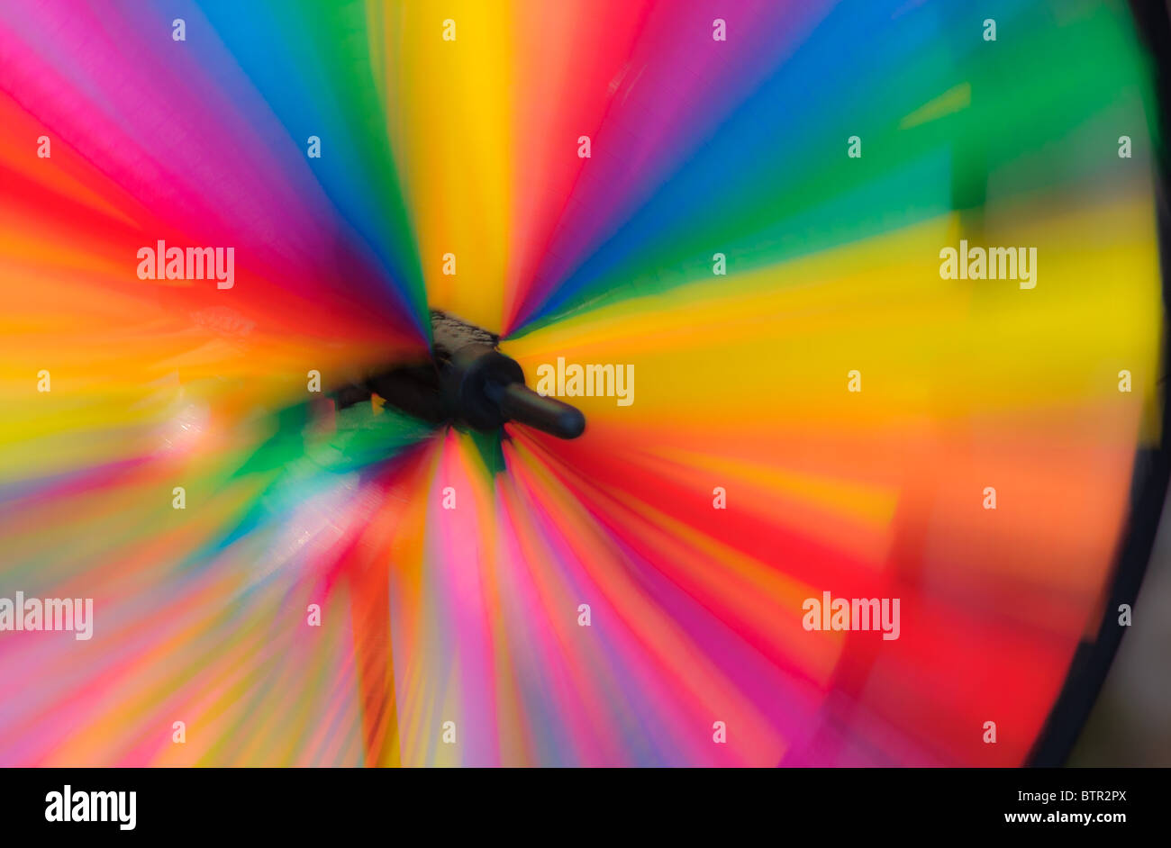 Spinning rainbow colored whirlygig Stock Photo - Alamy