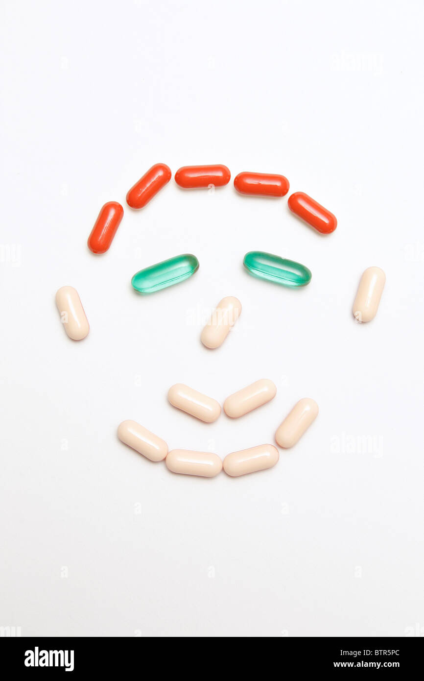 medication and pills face on gray background Stock Photo - Alamy