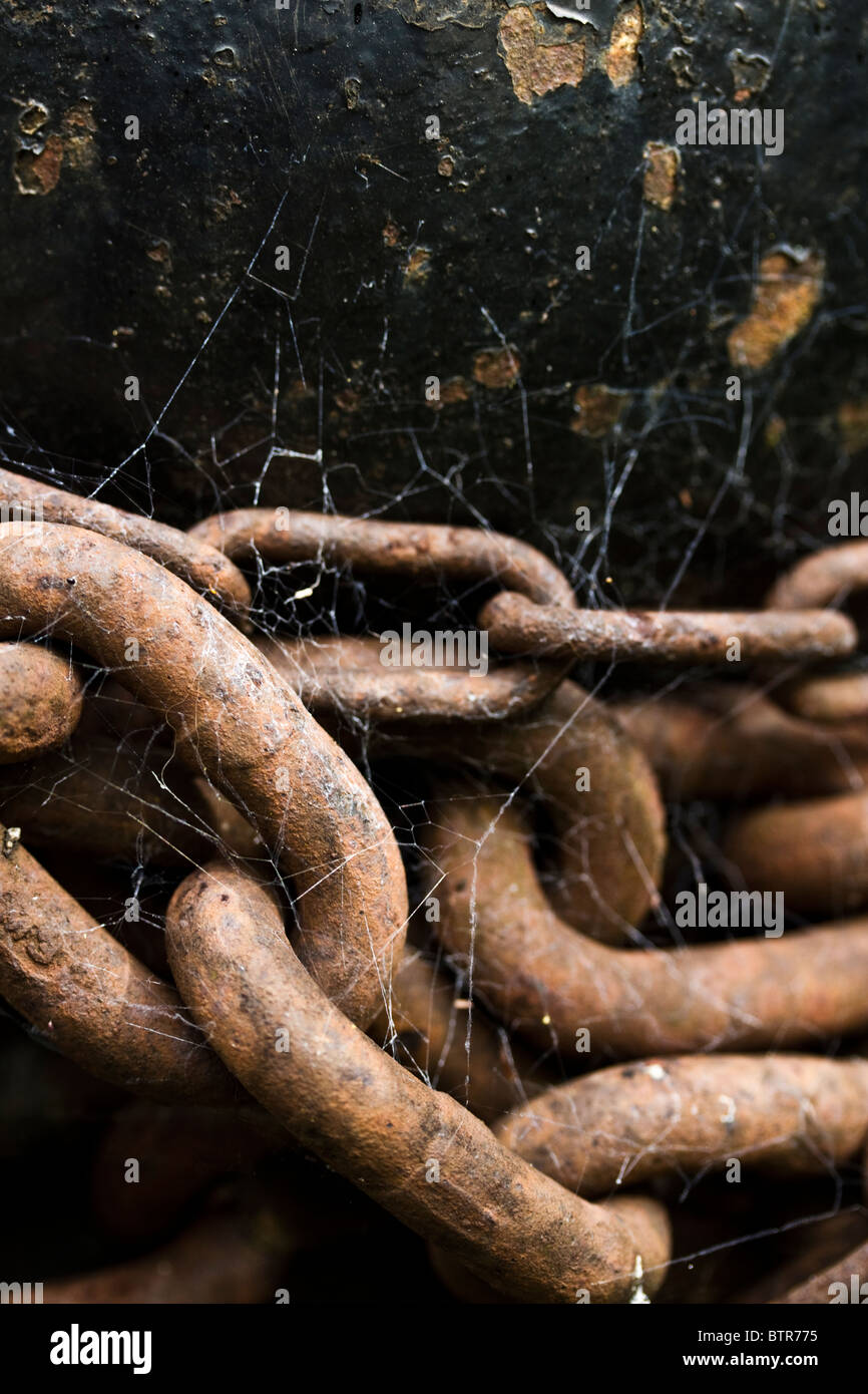 Rusting chains with cob web Stock Photo - Alamy