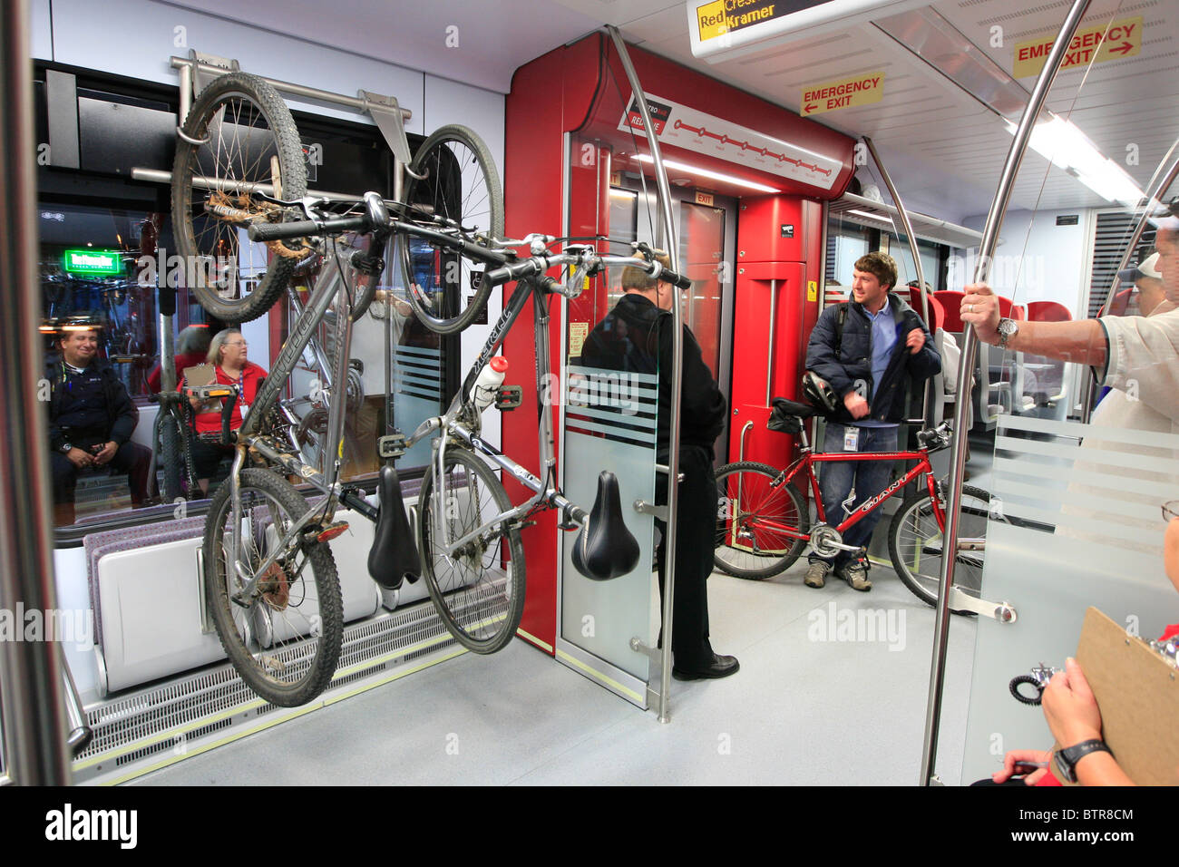 Morning commuter brings his bicycle on board a commuter rail car in ...