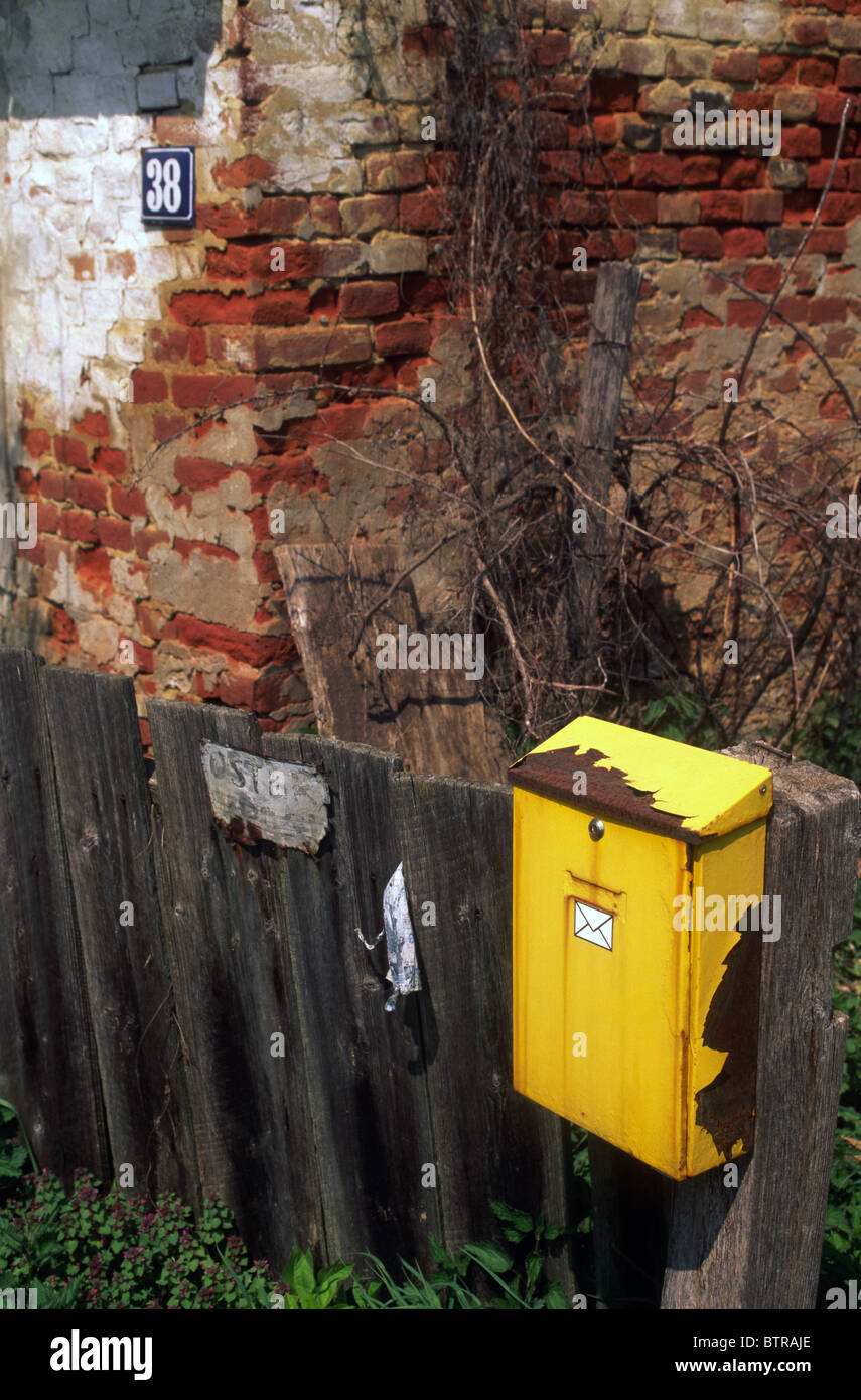 Old rust post box and ruined house Stock Photo - Alamy