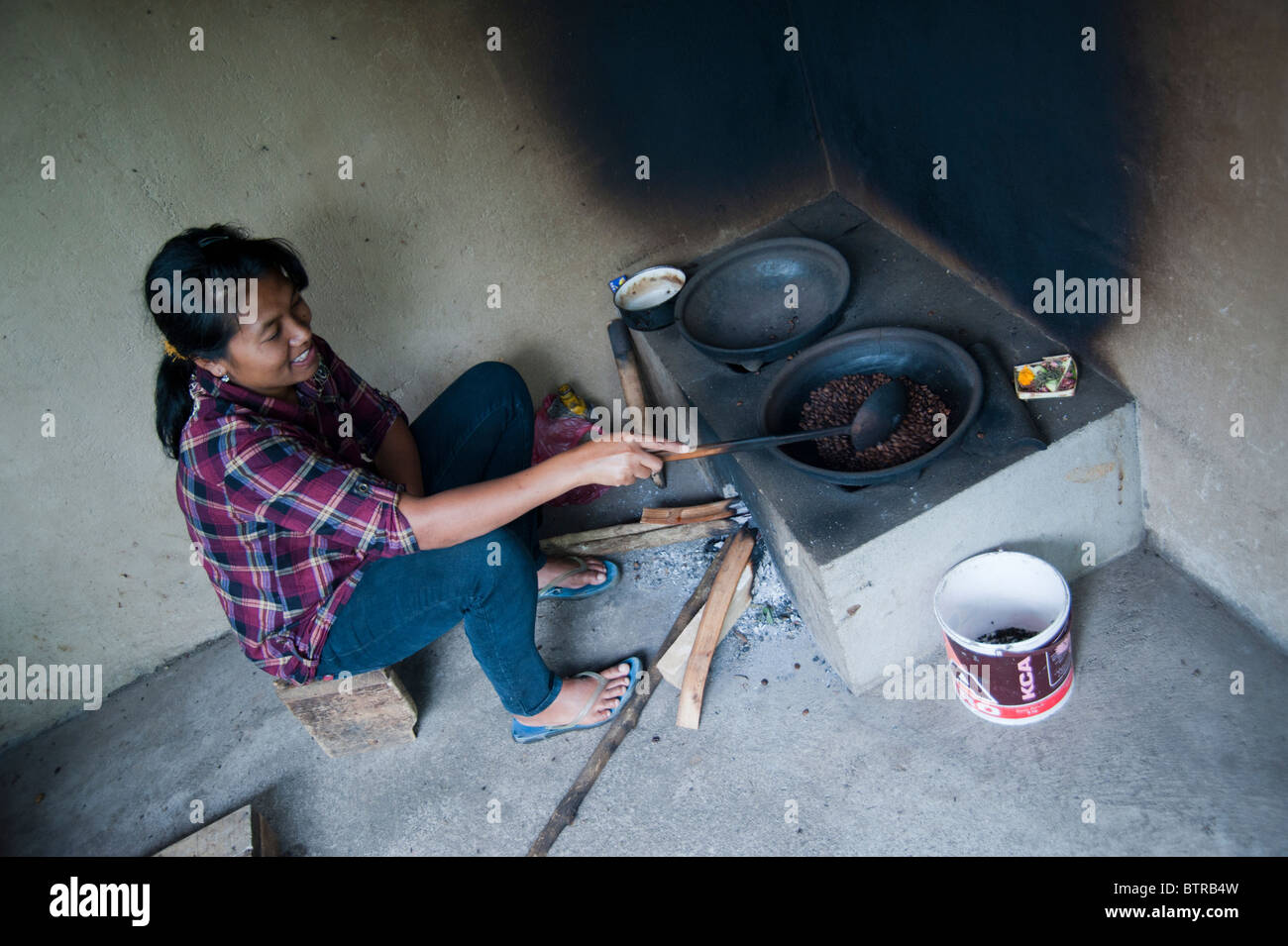Mongoose or Lewak coffee being roasted over a wood fire by worker in ...