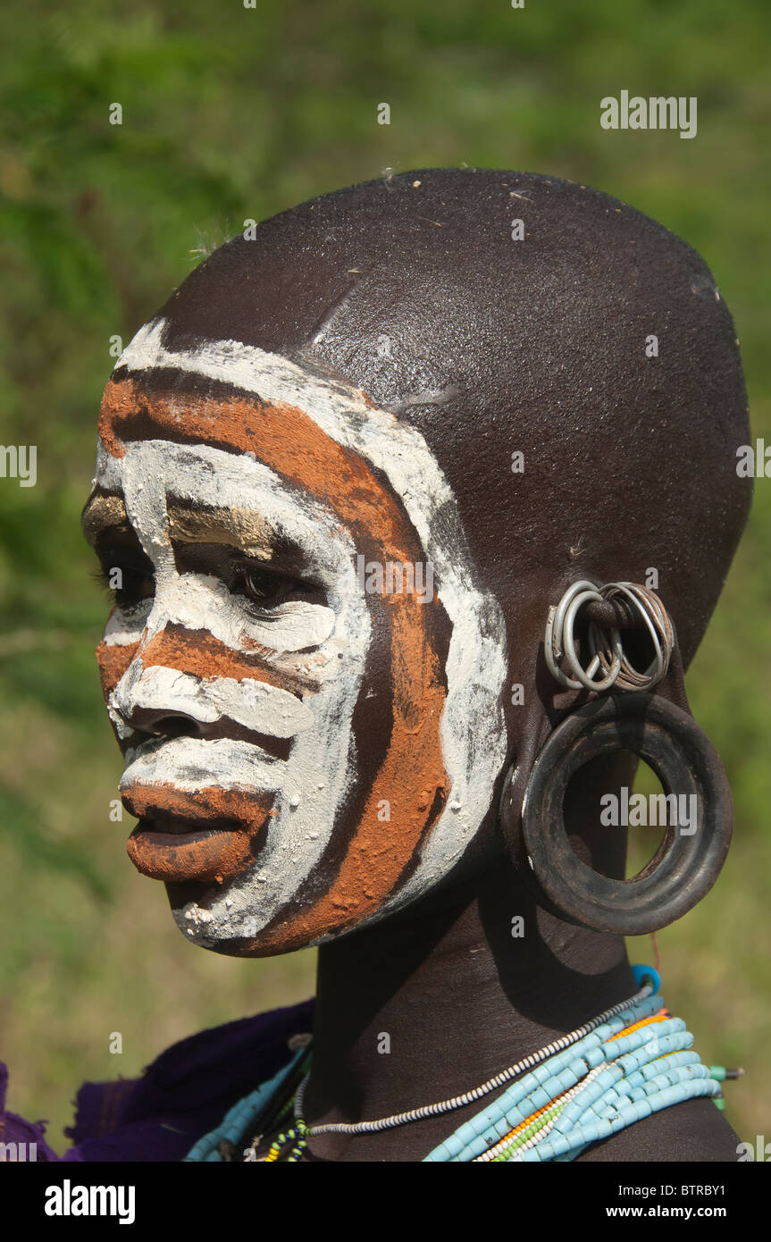 Young Surma woman with body paintings and ear plates, Kibish, Omo River ...