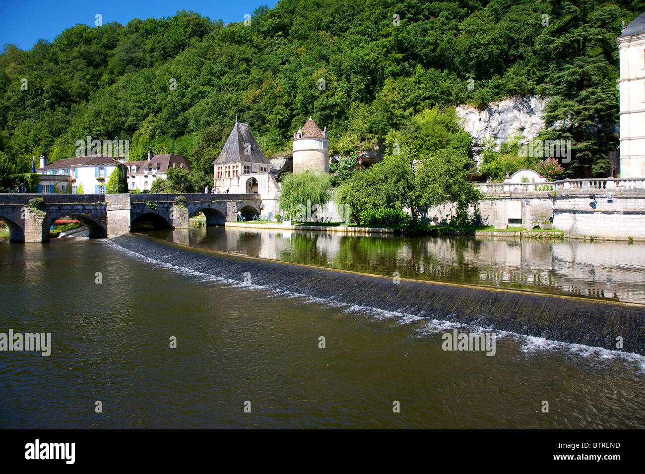 The river, weir, bridge and fortified buildings along the River Dronne ...