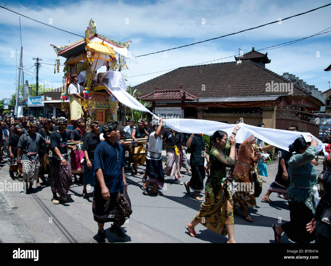Funeral procession making way down street in Bualu, Nusa Dua, Bali ...