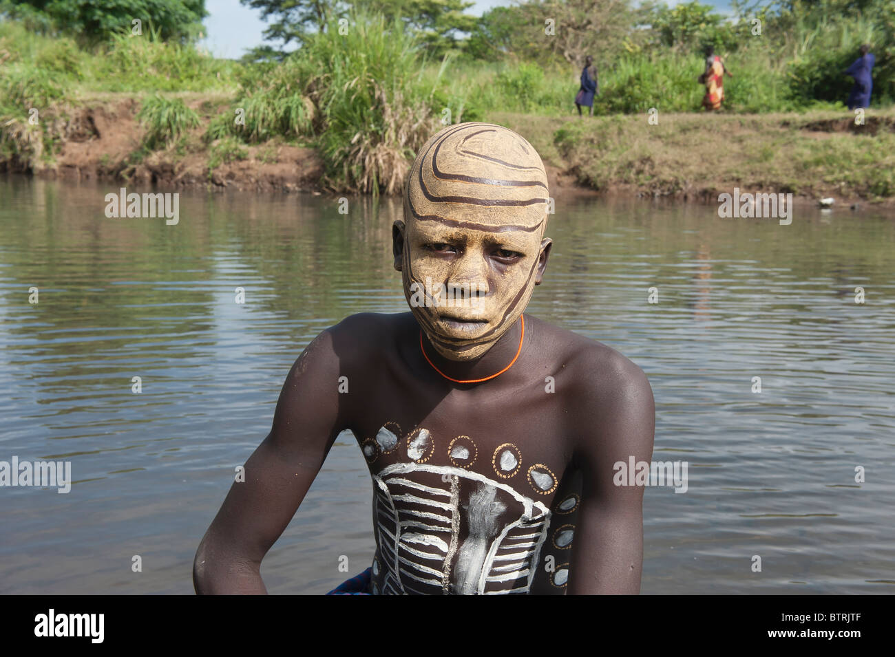 Surma boy in the river with body paintings, Kibish, Omo River Valley ...