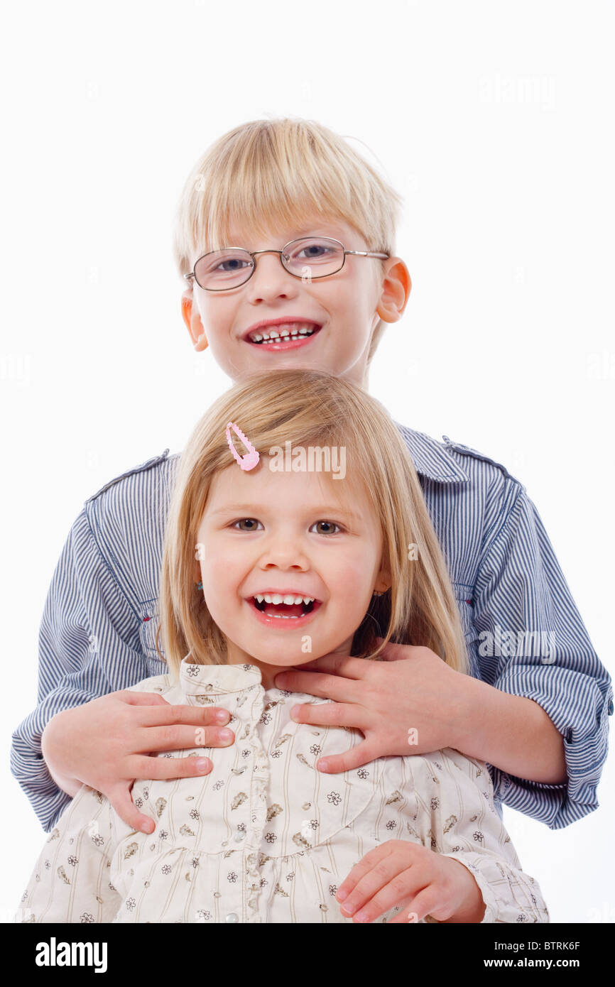 portrait of two young siblings looking at camera, smiling - isolated on ...