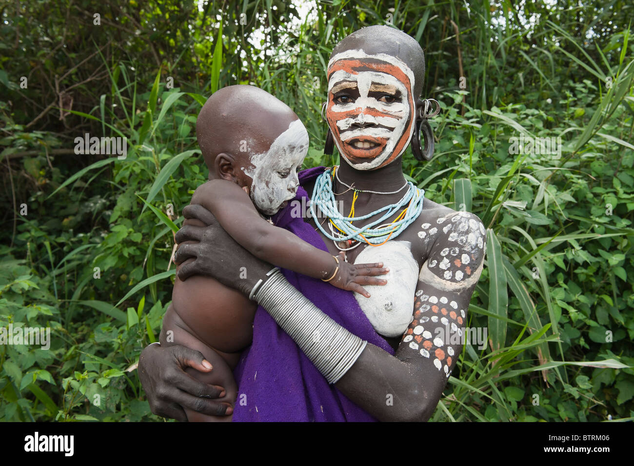 Surma woman with body paintings and holding her baby, Kibish, Omo River ...