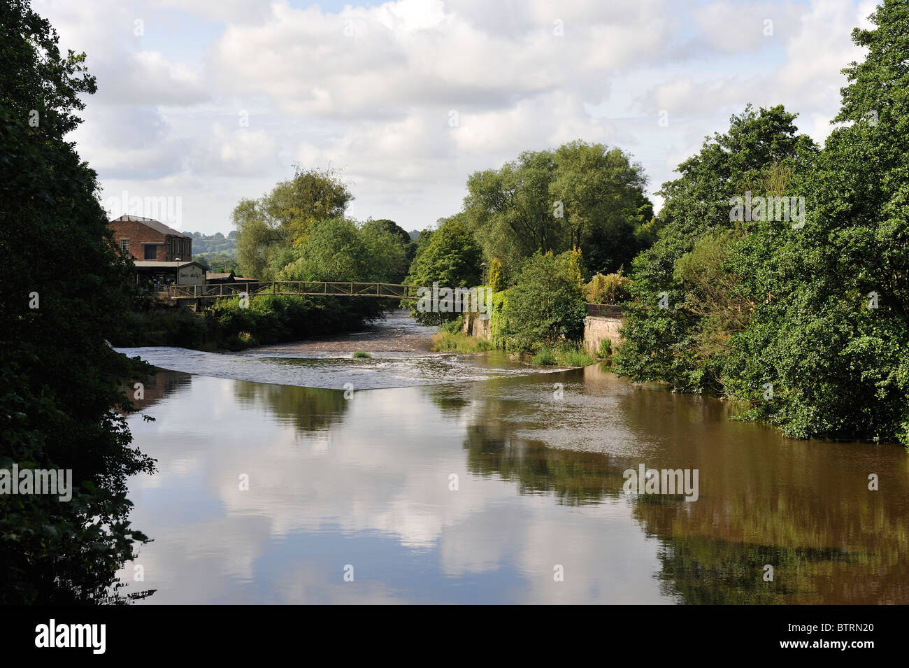 Weir on the River Derwent as it passes through Makeney in Belper ...