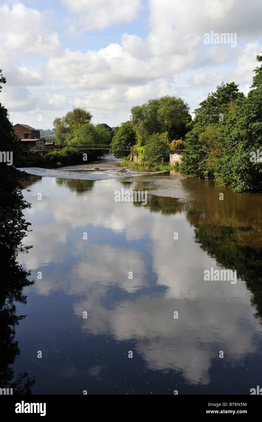 Clouds reflecting by a weir on the River Derwent as it passes through ...