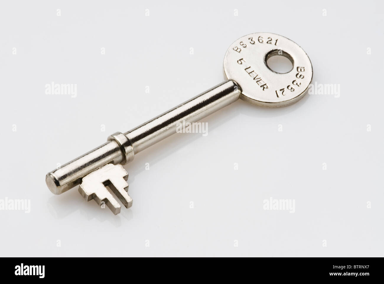Shiny chromium plated door key Stock Photo - Alamy