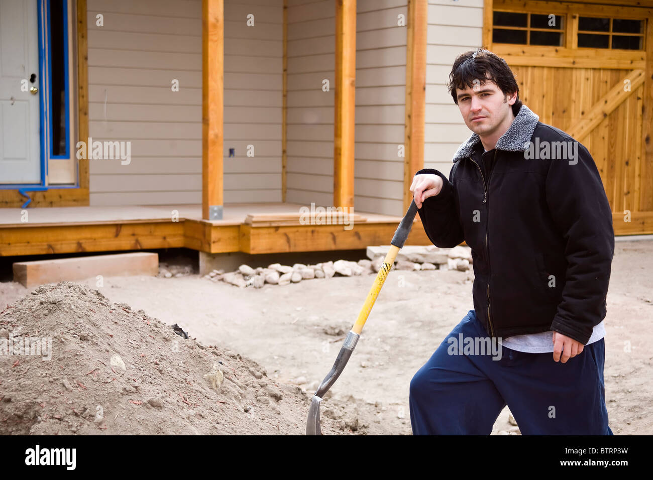 A construction worker in front of a new house Stock Photo - Alamy