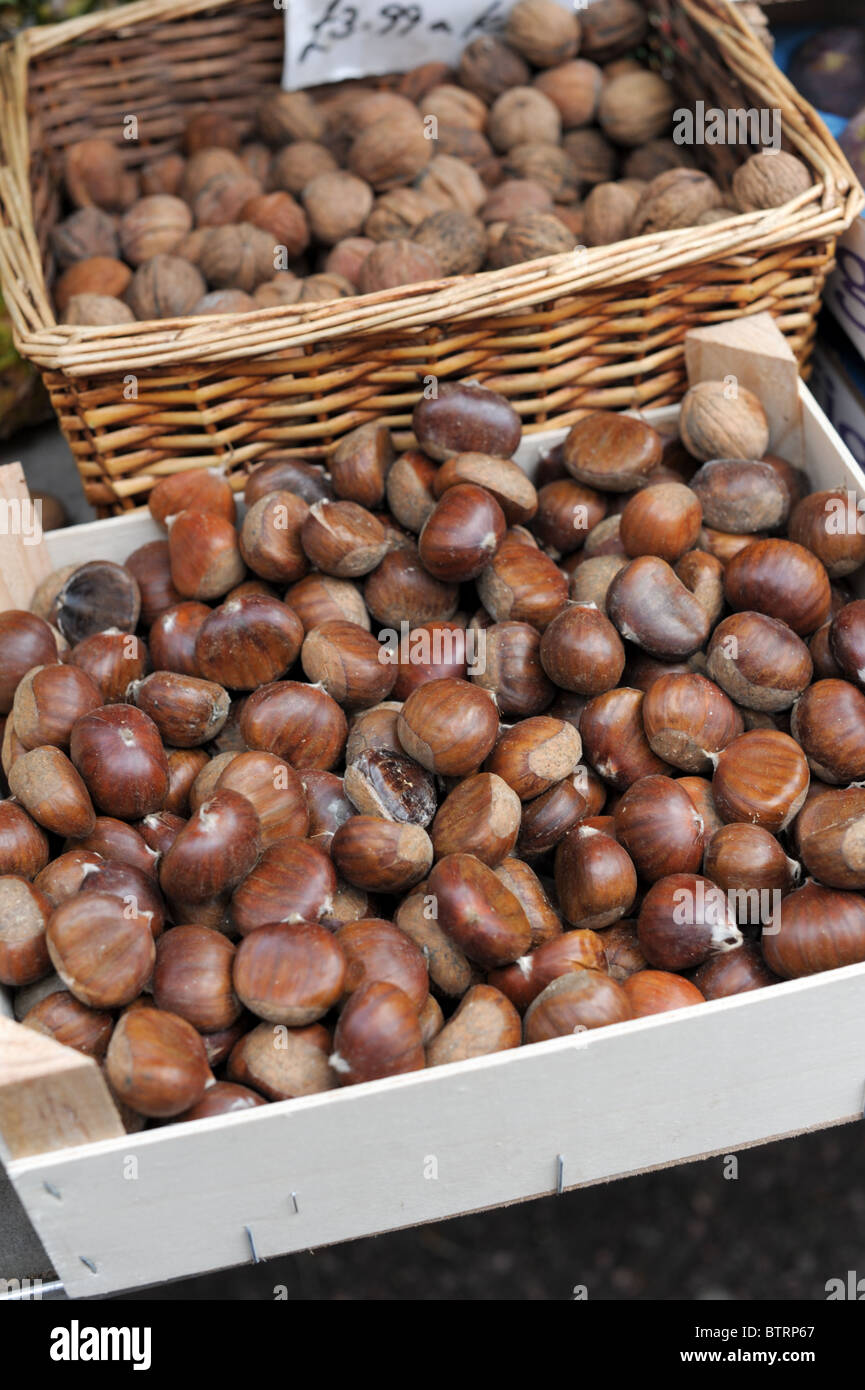 A box piled up with chestnuts ready for roasting on an open fire and ...