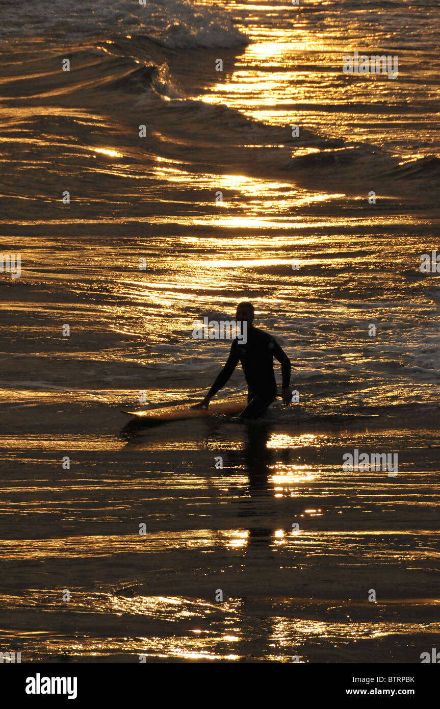 Man in sea at sunset Bournemouth Stock Photo - Alamy