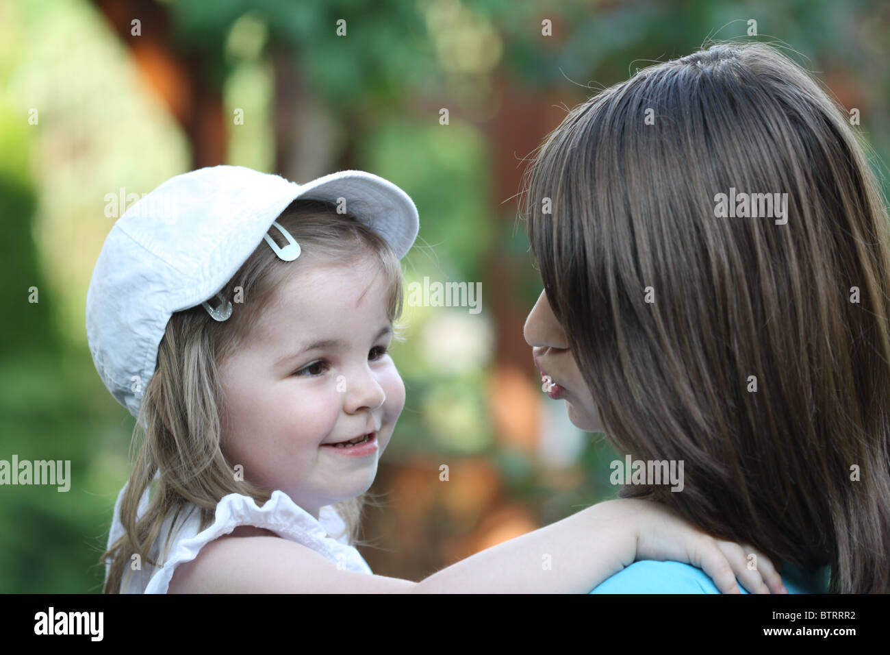 Two sisters in garden Stock Photo - Alamy
