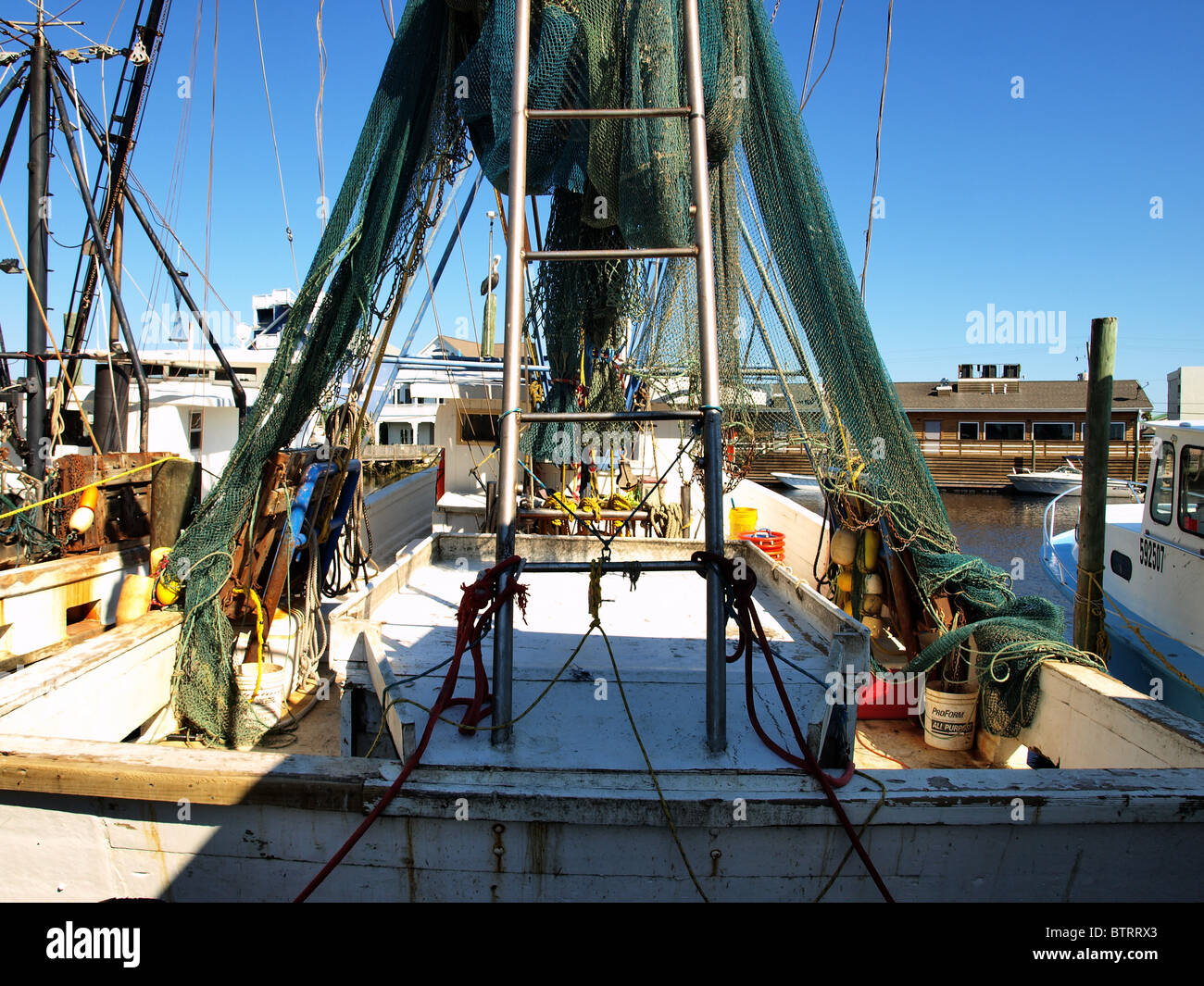 fishing boat commercial trawler with green nets out of water and up on ...