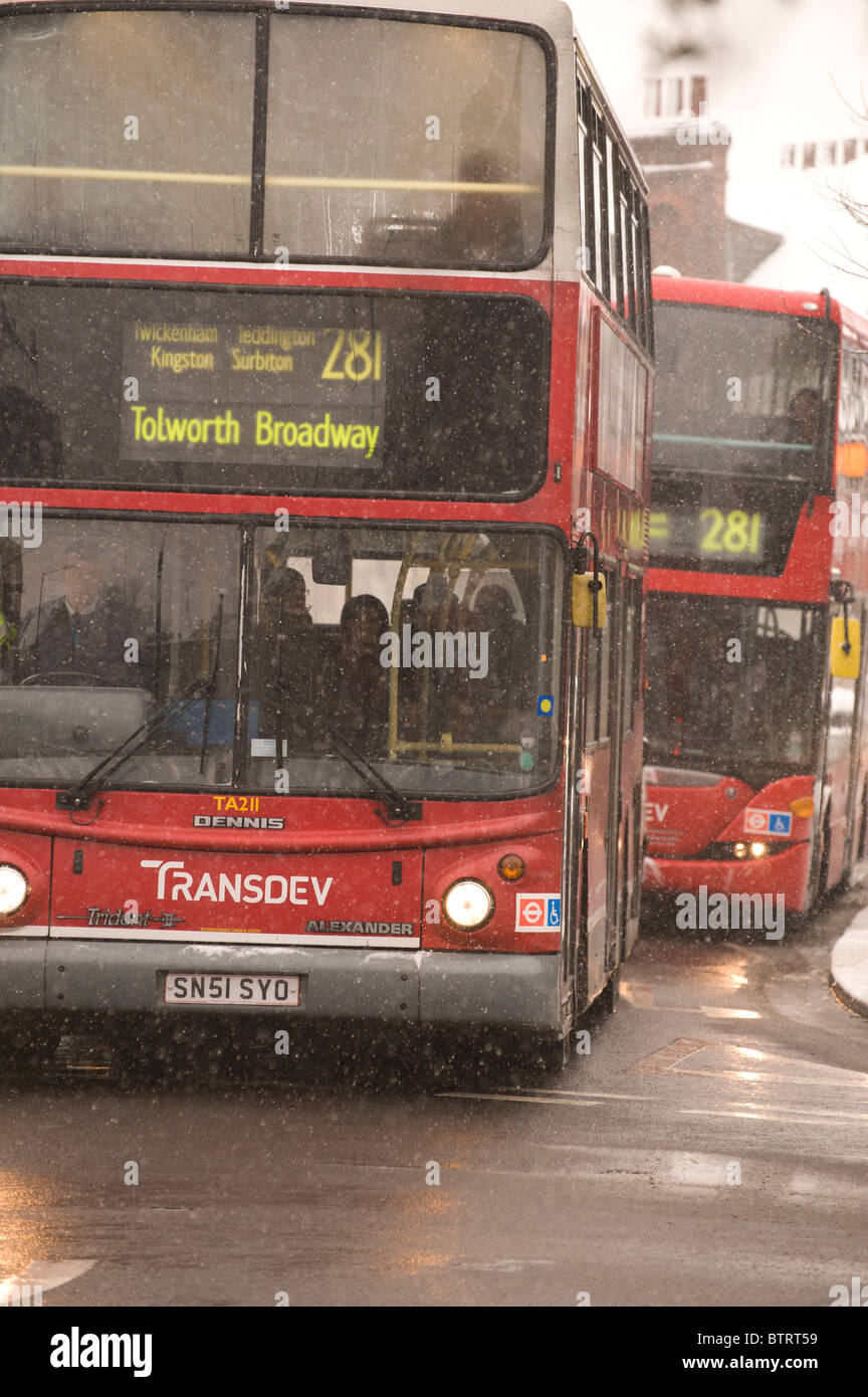 Two double-decker London buses in snowy weather Stock Photo - Alamy