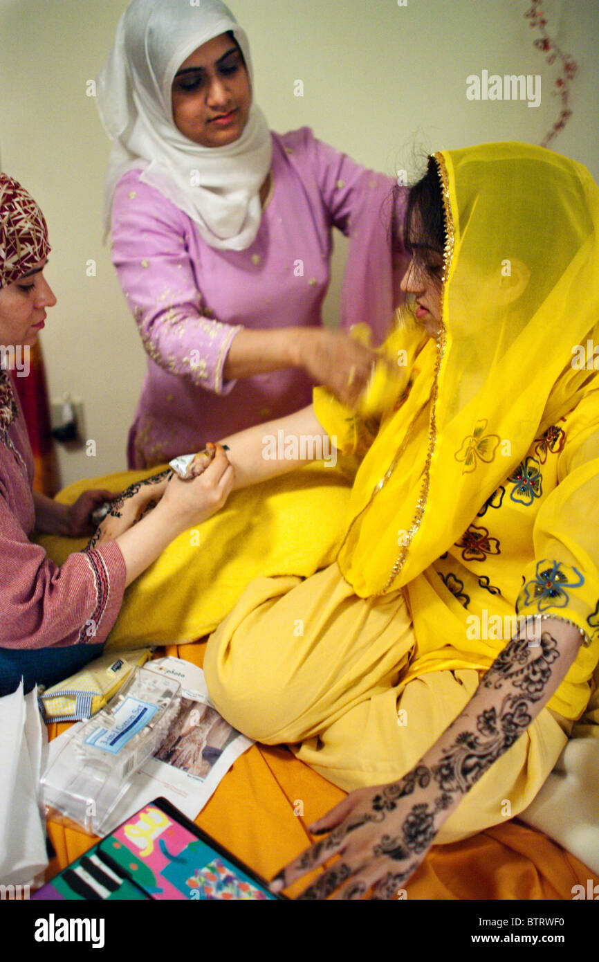 Young Muslim bride-to-be has elaborate henna designs painted on her ...