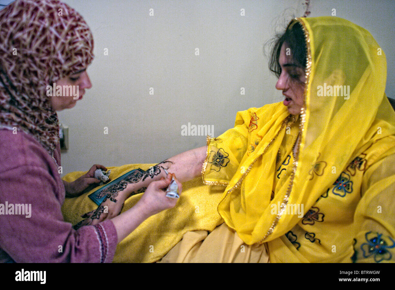 Young Muslim bride-to-be has elaborate henna designs painted on her ...