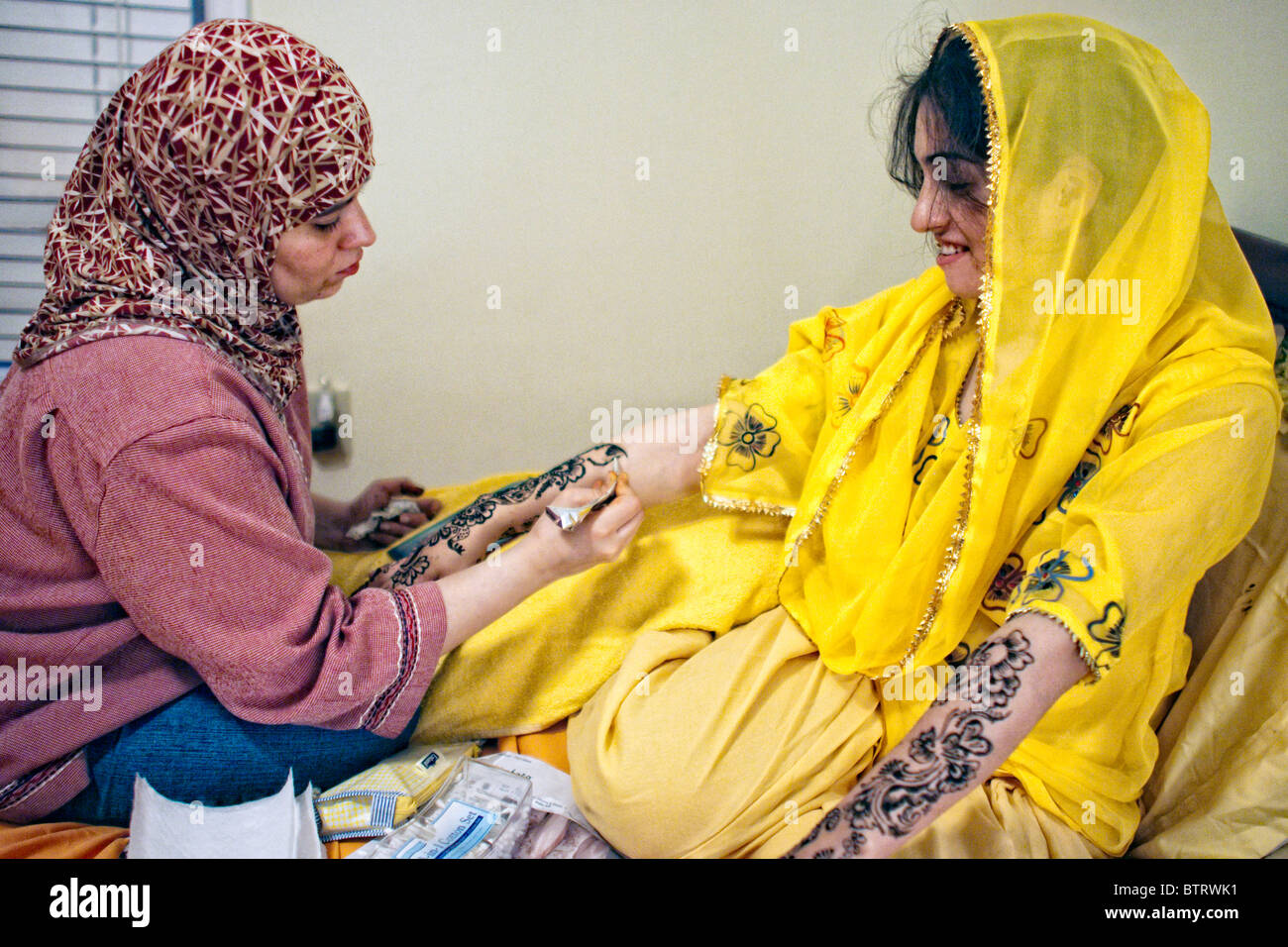 Young Muslim bride-to-be has elaborate henna designs painted on her ...