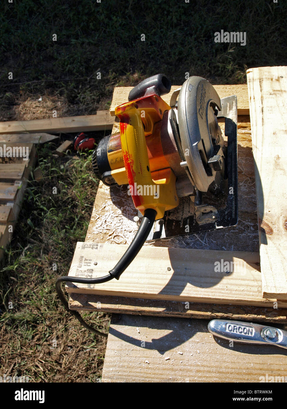 power saw blade hand construction building yellow on wood planks tool ...