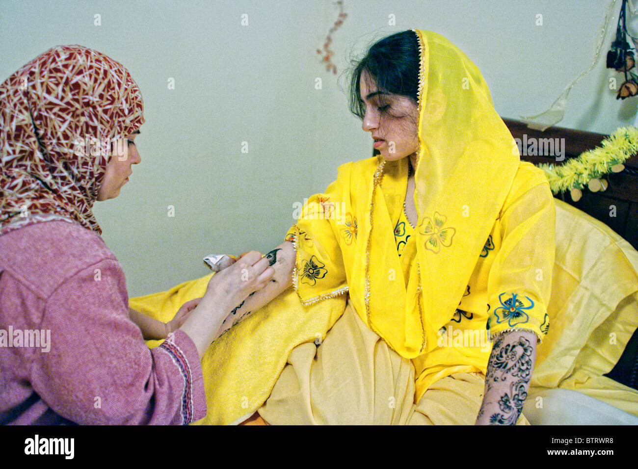 Young Muslim bride-to-be has elaborate henna designs painted on her ...