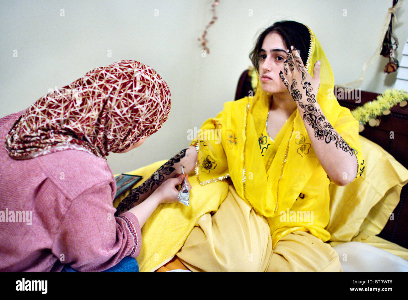 Young Muslim bride-to-be has elaborate henna designs painted on her ...