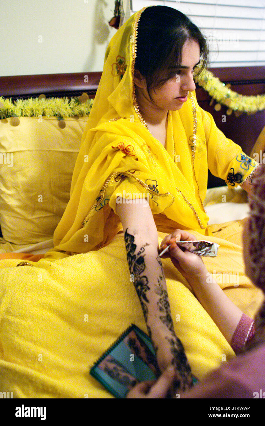 Young Muslim bride-to-be has elaborate henna designs painted on her ...
