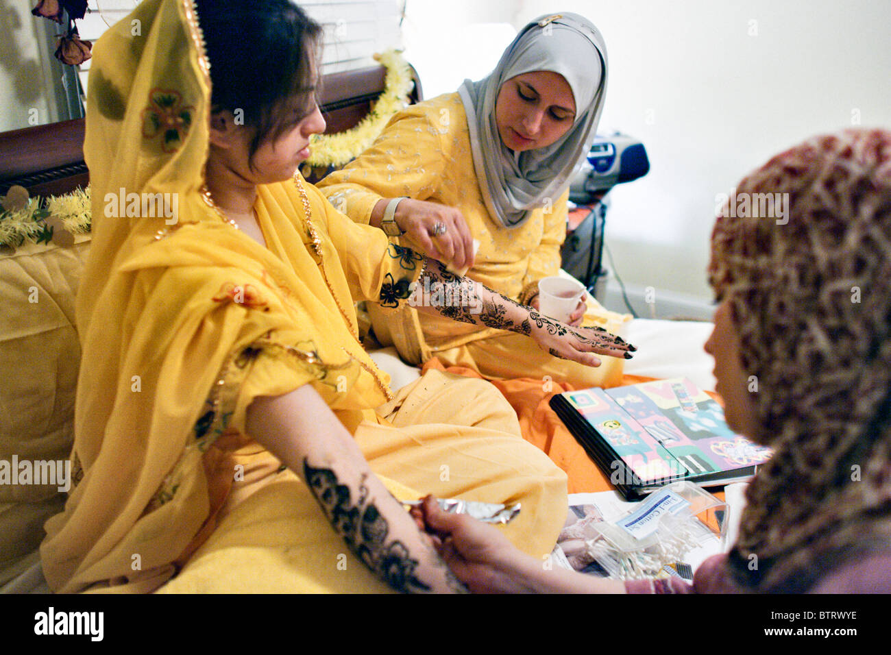 Young Muslim bride-to-be has elaborate henna designs painted on her ...