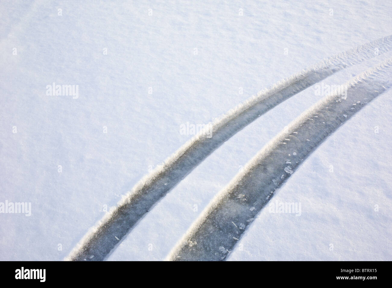 Tire imprints in snow Stock Photo - Alamy