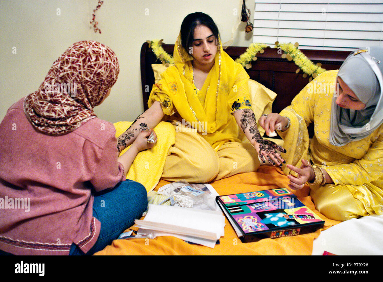 Young Muslim bride-to-be has elaborate henna designs painted on her ...