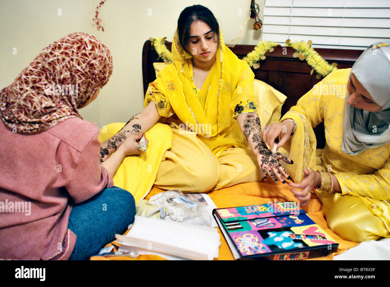 Young Muslim bride-to-be has elaborate henna designs painted on her ...