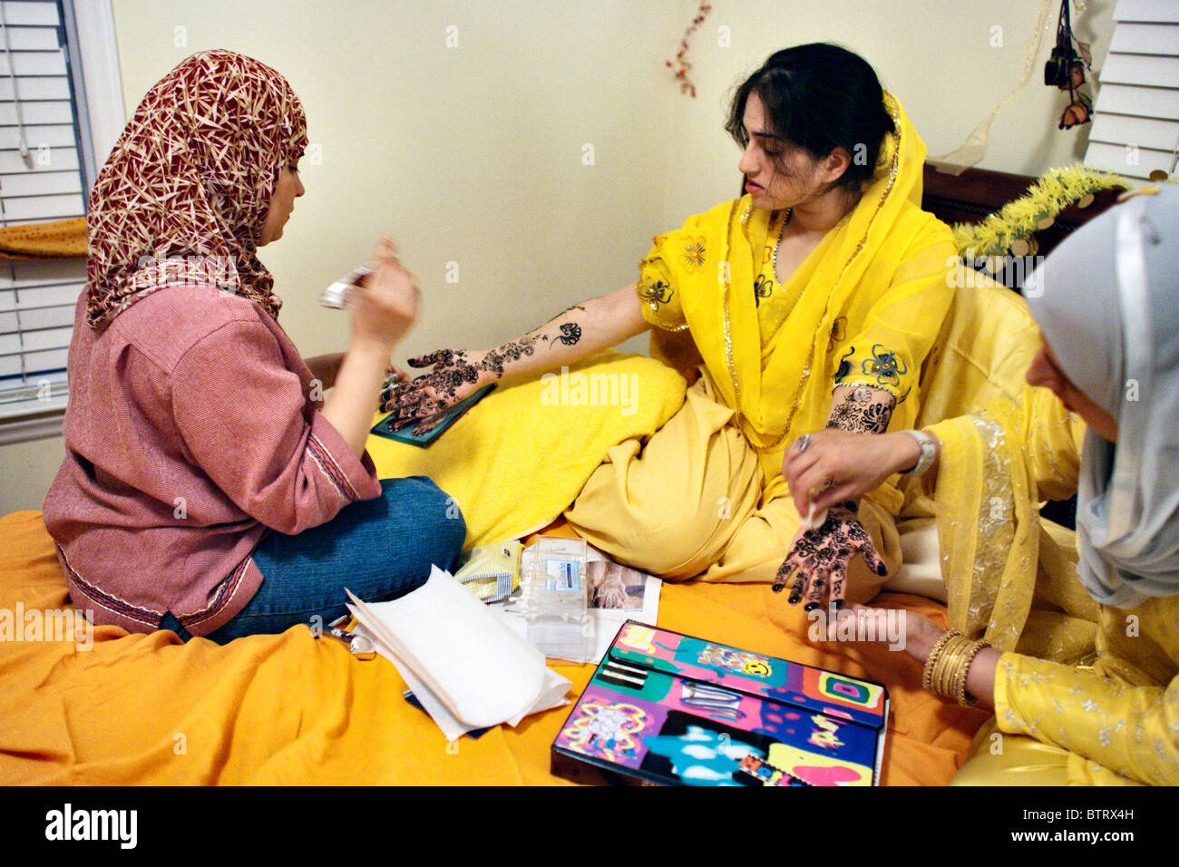 Young Muslim bride-to-be has elaborate henna designs painted on her ...