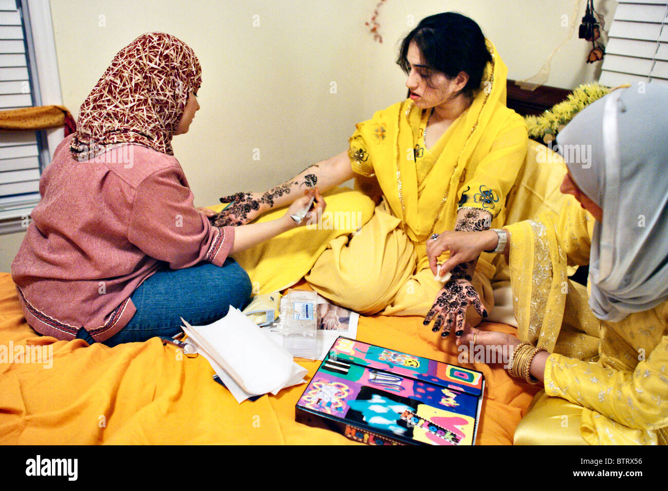 Young Muslim bride-to-be has elaborate henna designs painted on her ...