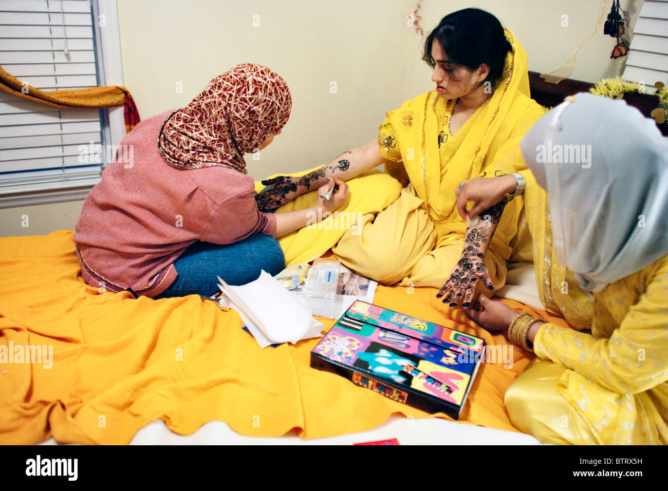 Young Muslim bride-to-be has elaborate henna designs painted on her ...